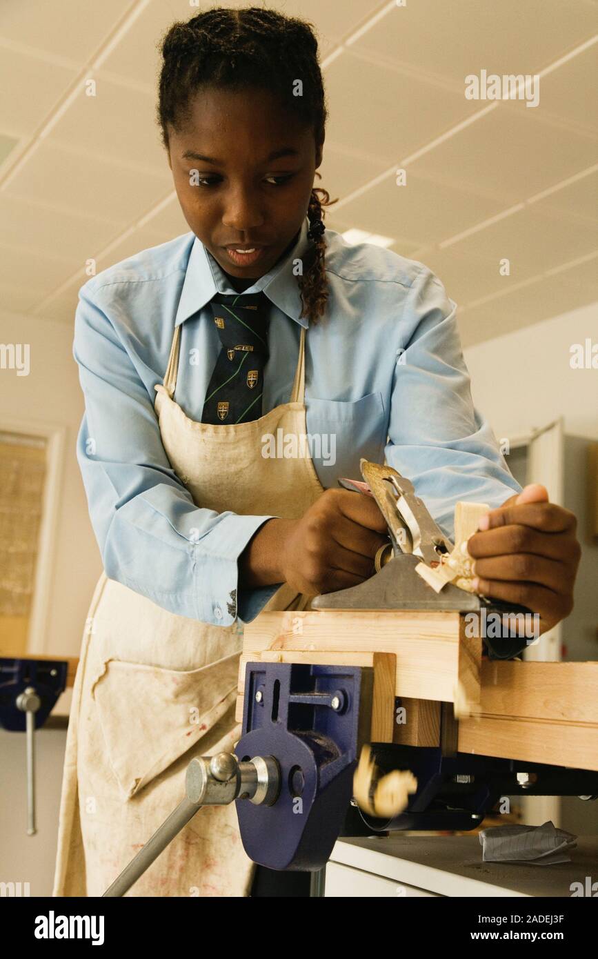Secondary school student using a plane in Design technology lesson ...