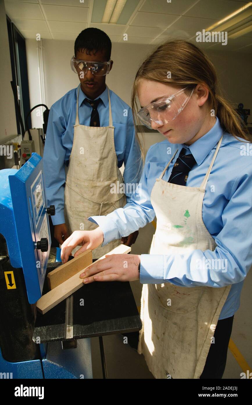 Secondary school student cutting machine to shape wood in a Design ...
