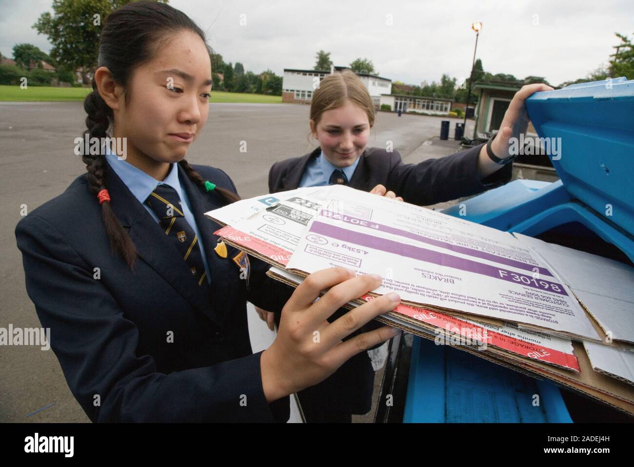 Secondary school students recycling old cardboard boxes in school ...