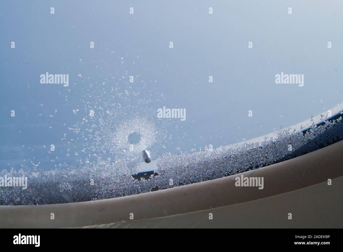 Close-up on the frost on the window of an aircraft during a Paris - Ho ...