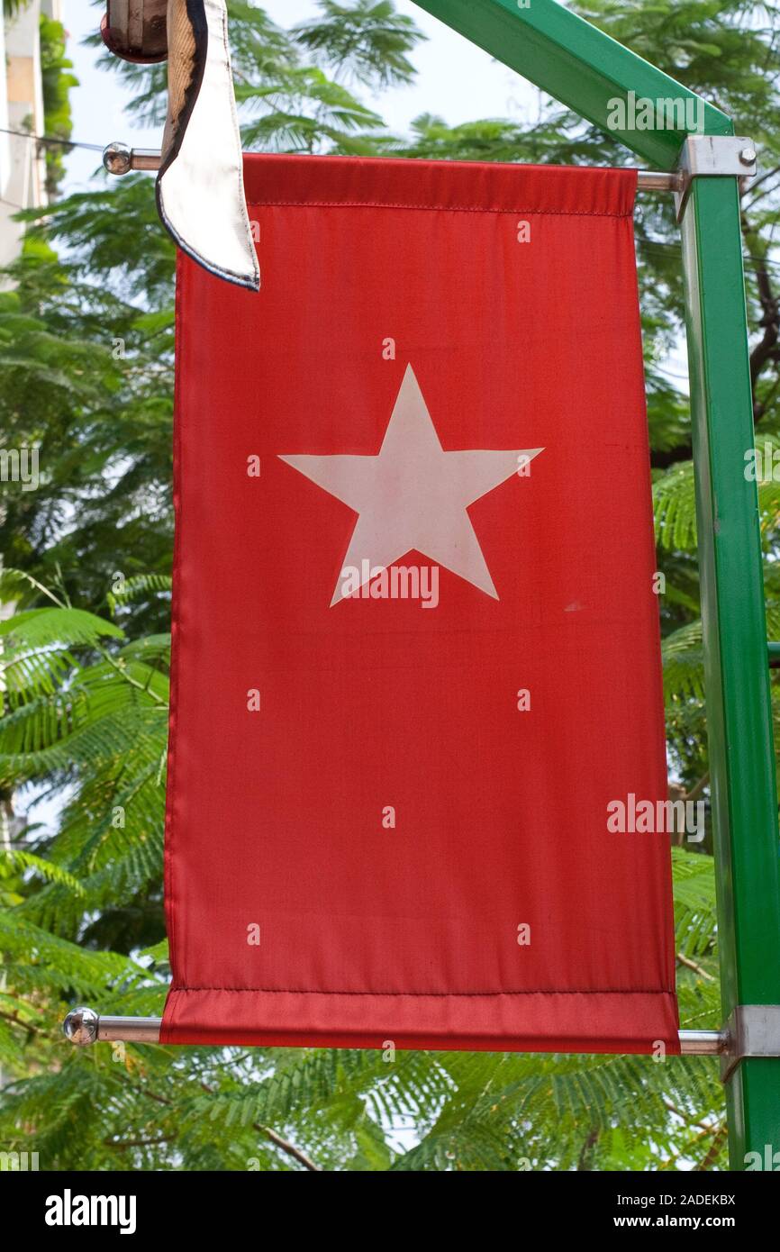 Close-up on the vietnamese flag hanging from a street lamp, on one of ...