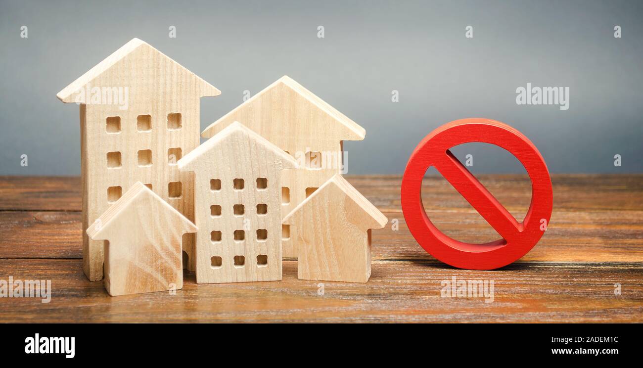 Wooden houses and a prohibition sign. Inaccessible and expensive ...