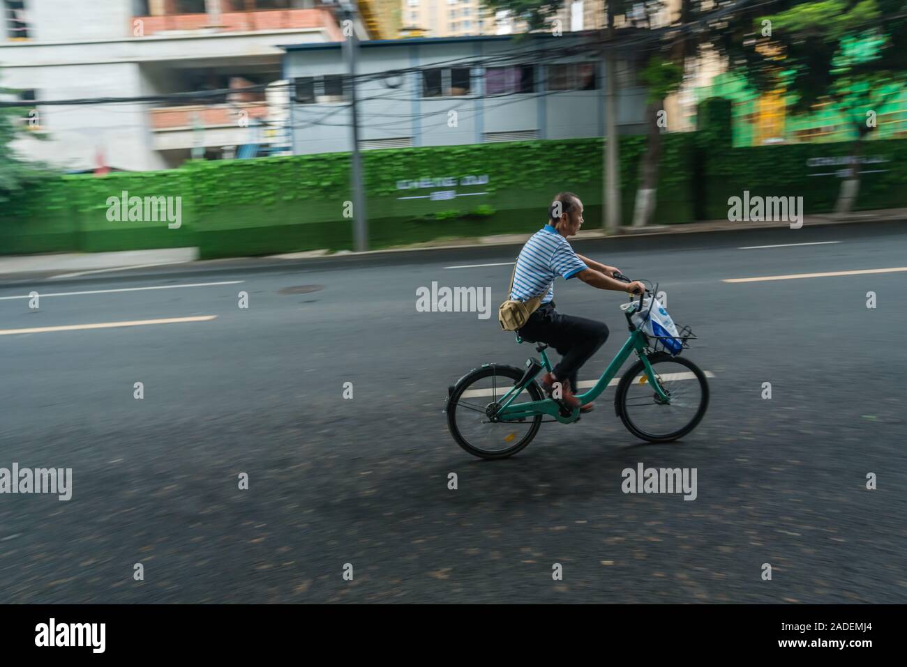 Chinese man cycling hi-res stock photography and images - Alamy