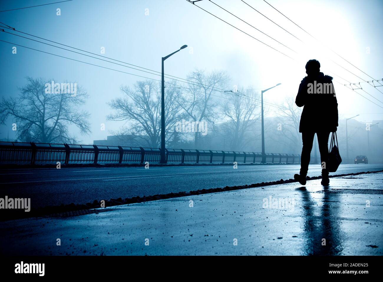 mysterious woman figure walking along a bridge Stock Photo - Alamy