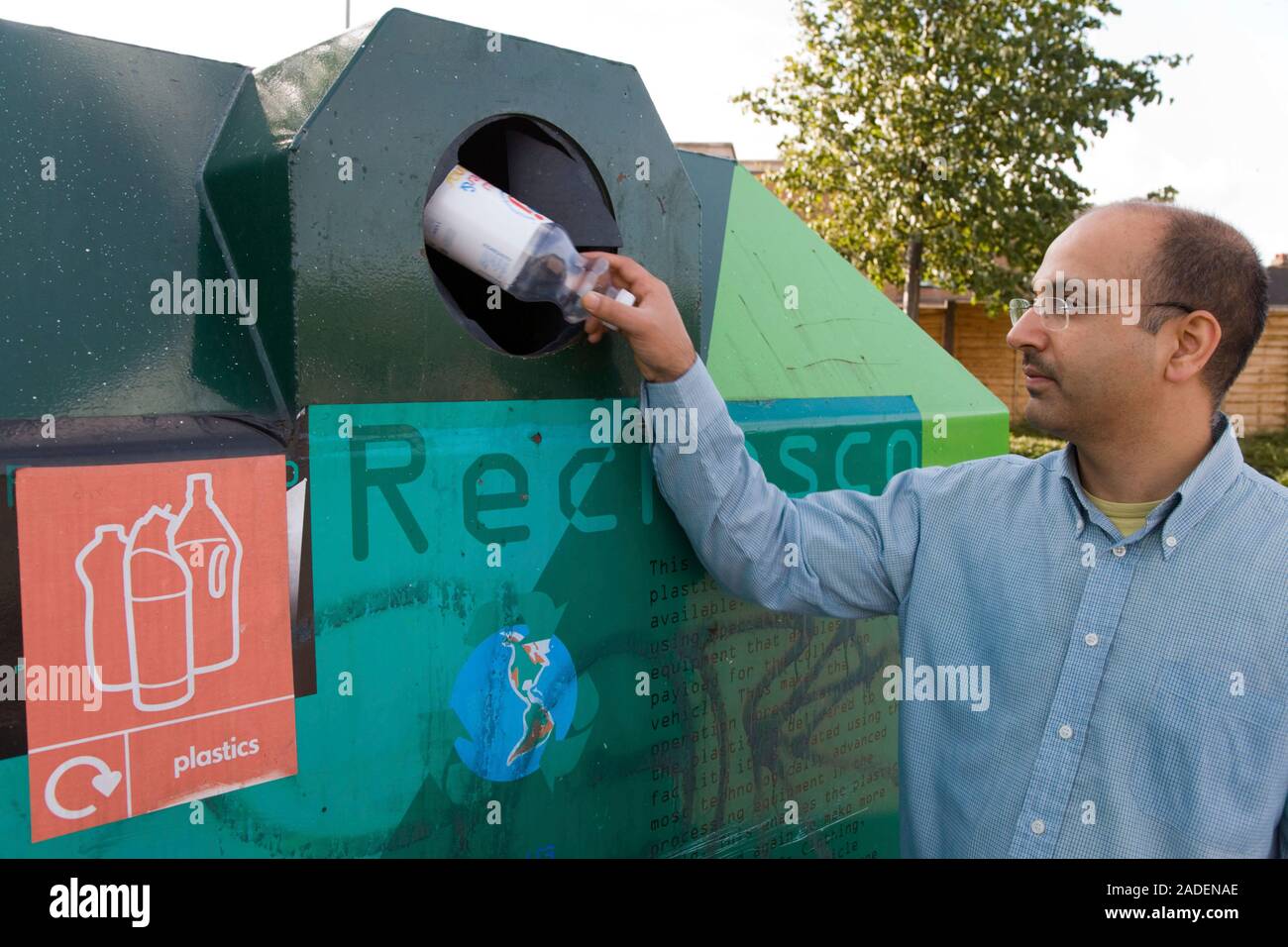 Man recycling a plastic bottle Stock Photo - Alamy