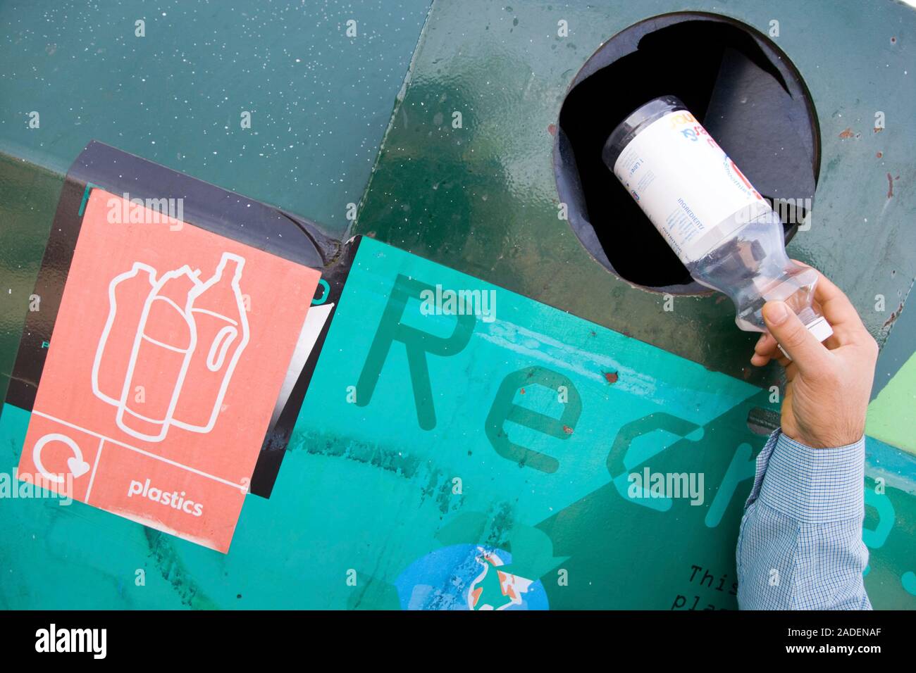 Man recycling a plastic bottle Stock Photo - Alamy
