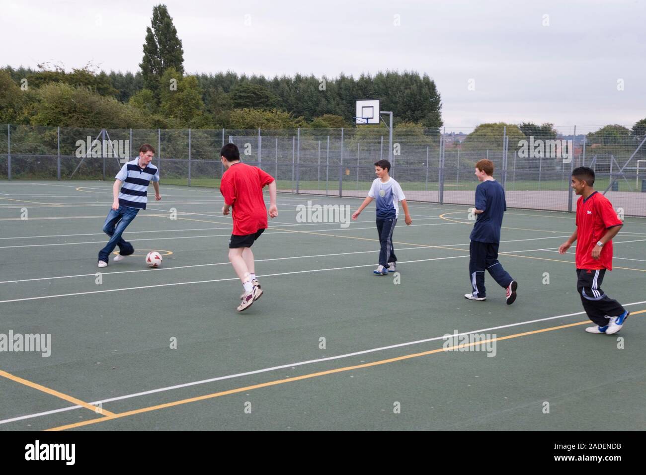 Group of teenage boys having a kick about with a football Stock Photo ...