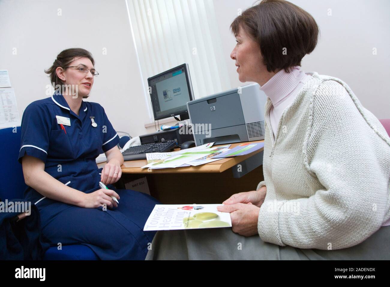 Community nurse discussing health issues with patient Stock Photo - Alamy