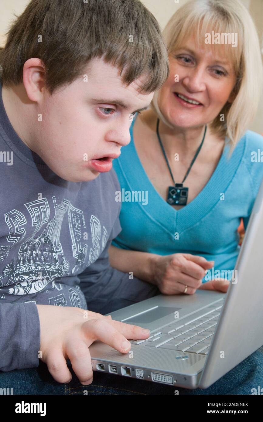 Mother and teenage son with Down Syndrome using a laptop computer Stock ...