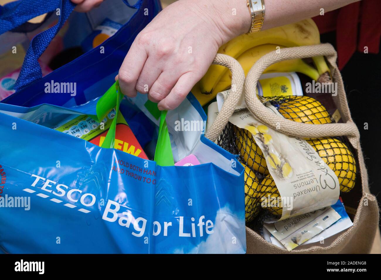 Woman carrying her shopping in reusable 'bags for life' shopping bags ...