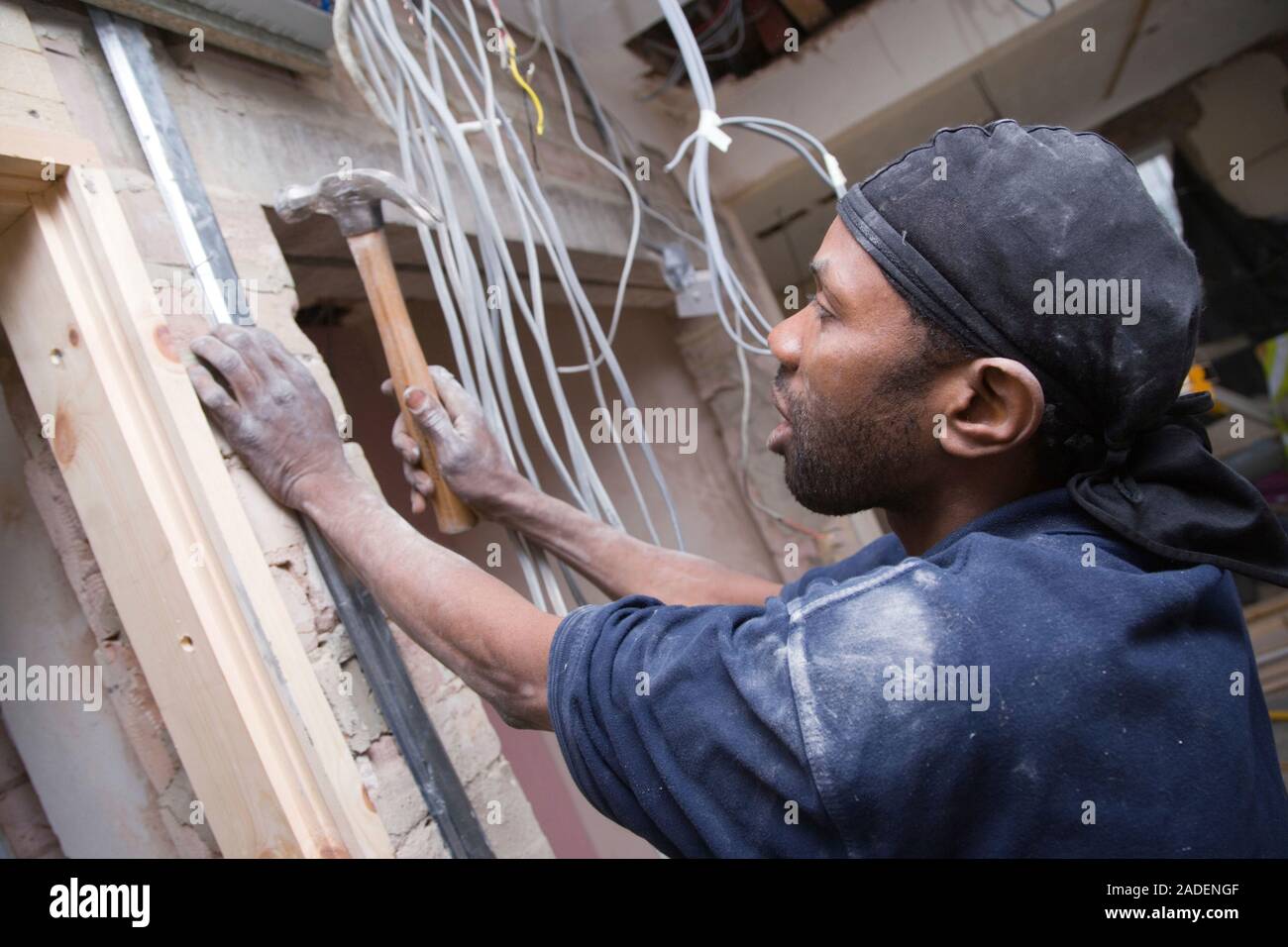 Electrician installing cables Stock Photo - Alamy