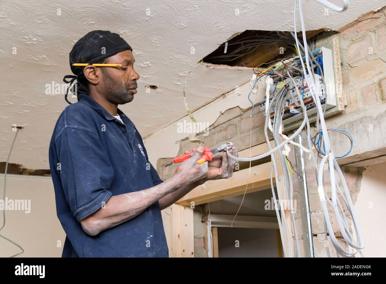Electrician installing cables Stock Photo - Alamy