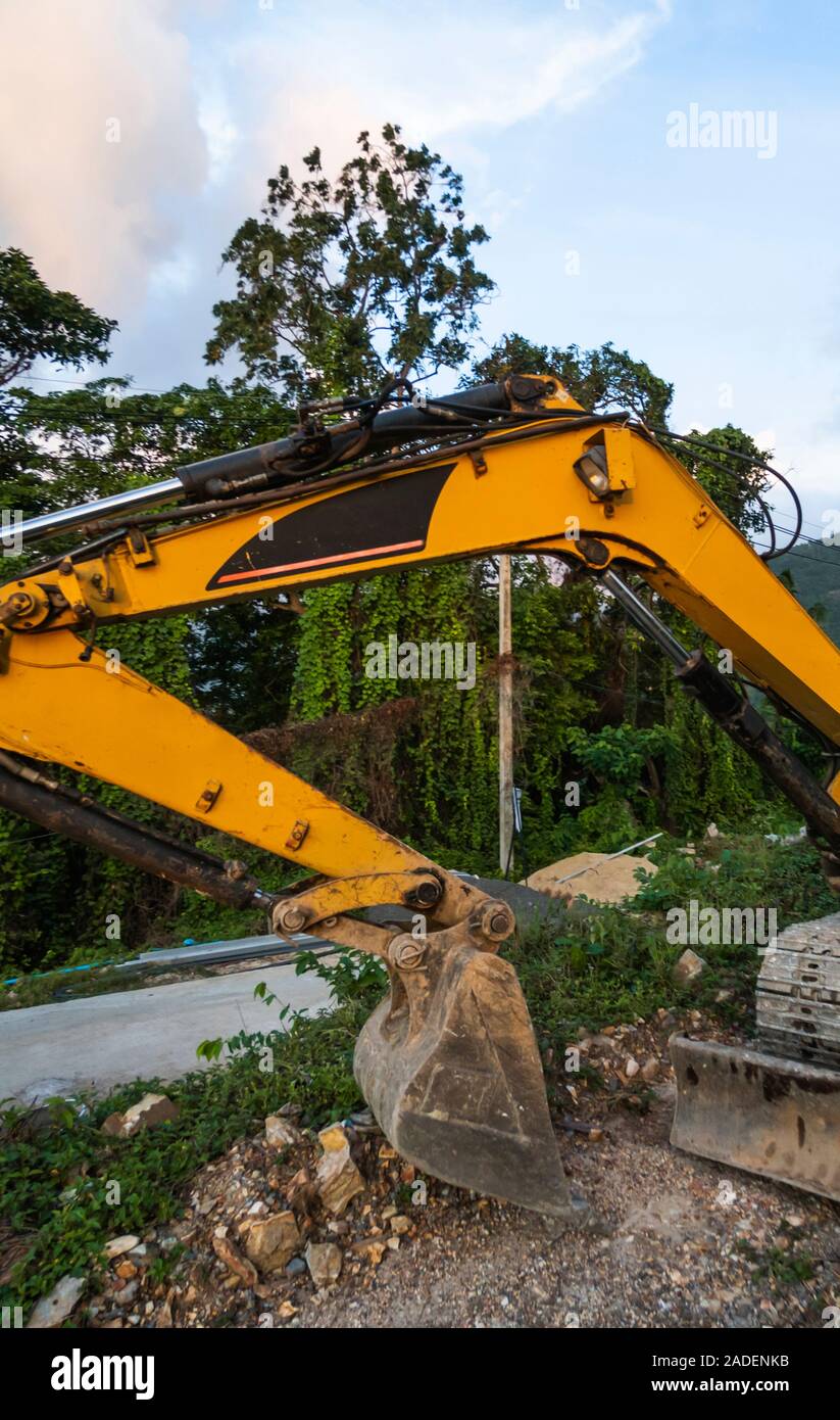 The modern excavator on the construction site with sunset sky. Large ...