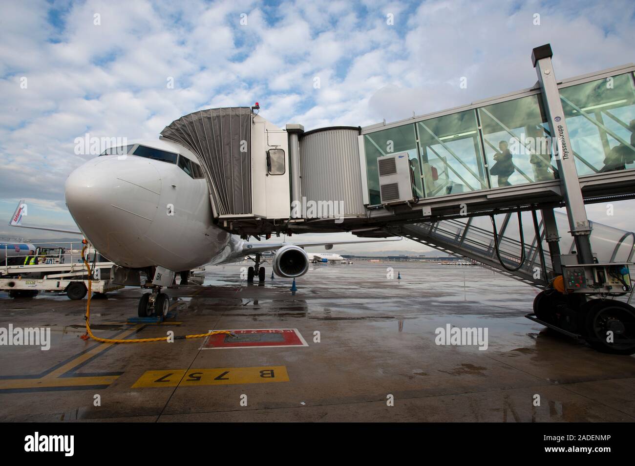 Barcelona airport. Passengers boarding a plane through a boarding ...
