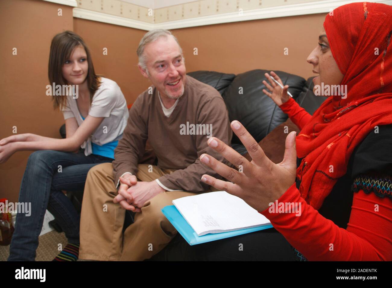 Professional visiting family at home Stock Photo - Alamy