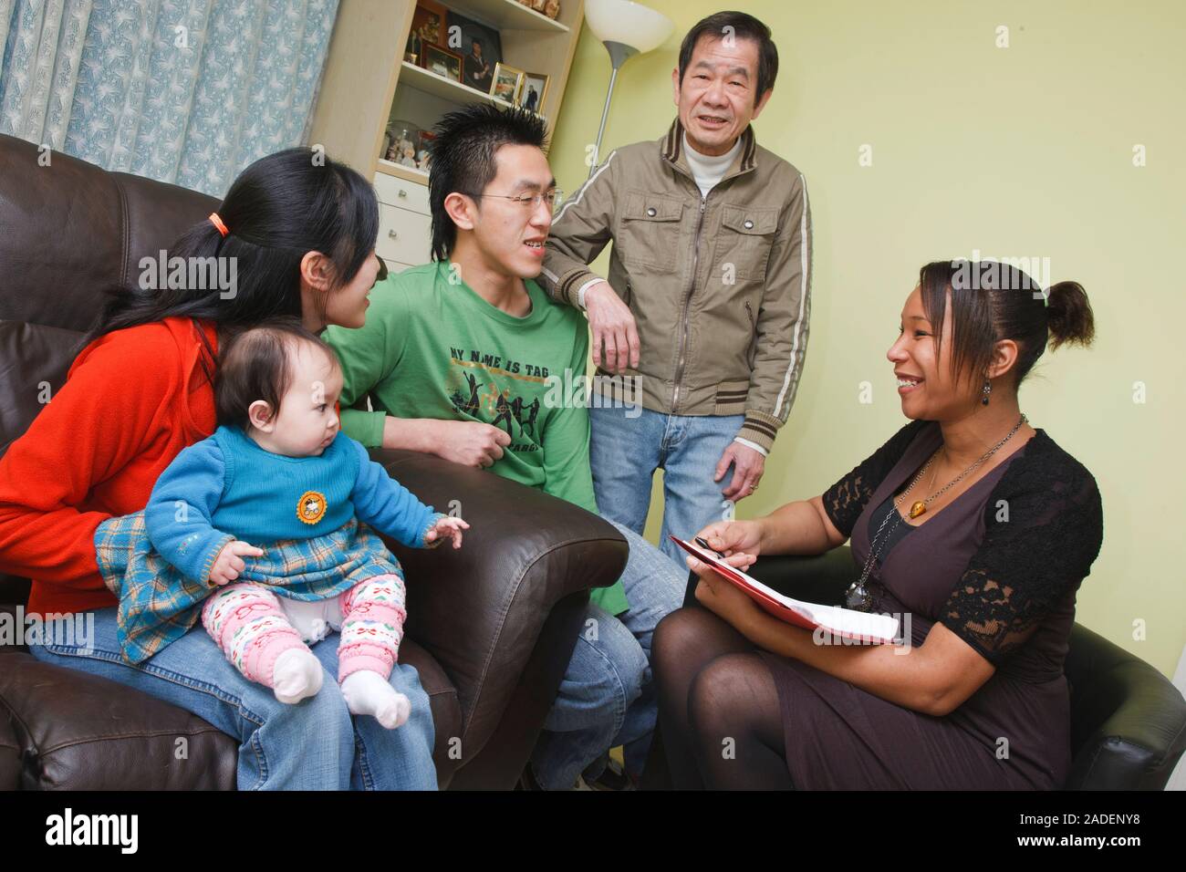 Professional visiting Chinese family at home Stock Photo - Alamy