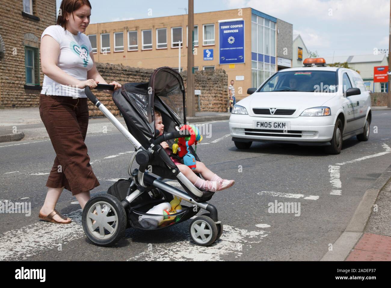 Mother crossing road with baby Stock Photo - Alamy