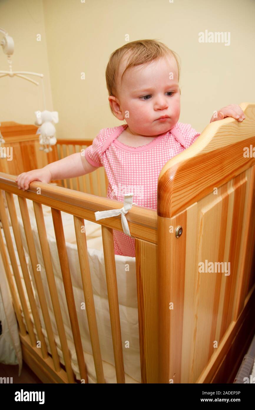 Baby in cot Stock Photo - Alamy