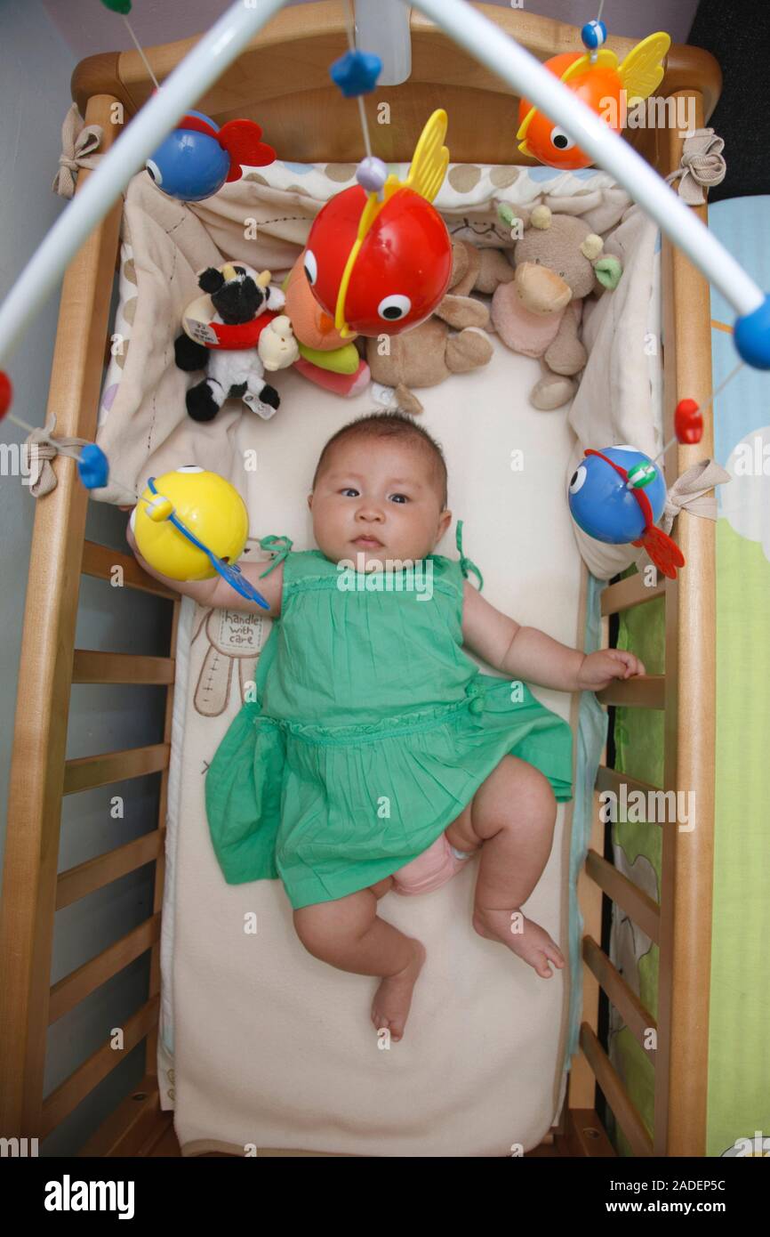 Chinese baby lying in cot Stock Photo - Alamy