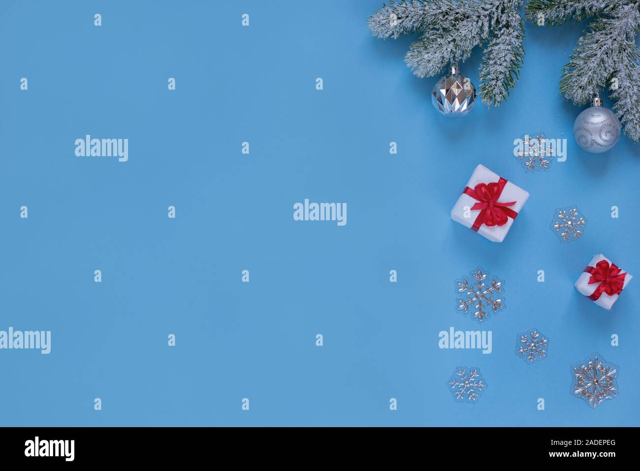 Snowy sprigs of pine with christmas balls, snowflakes and christmas ...