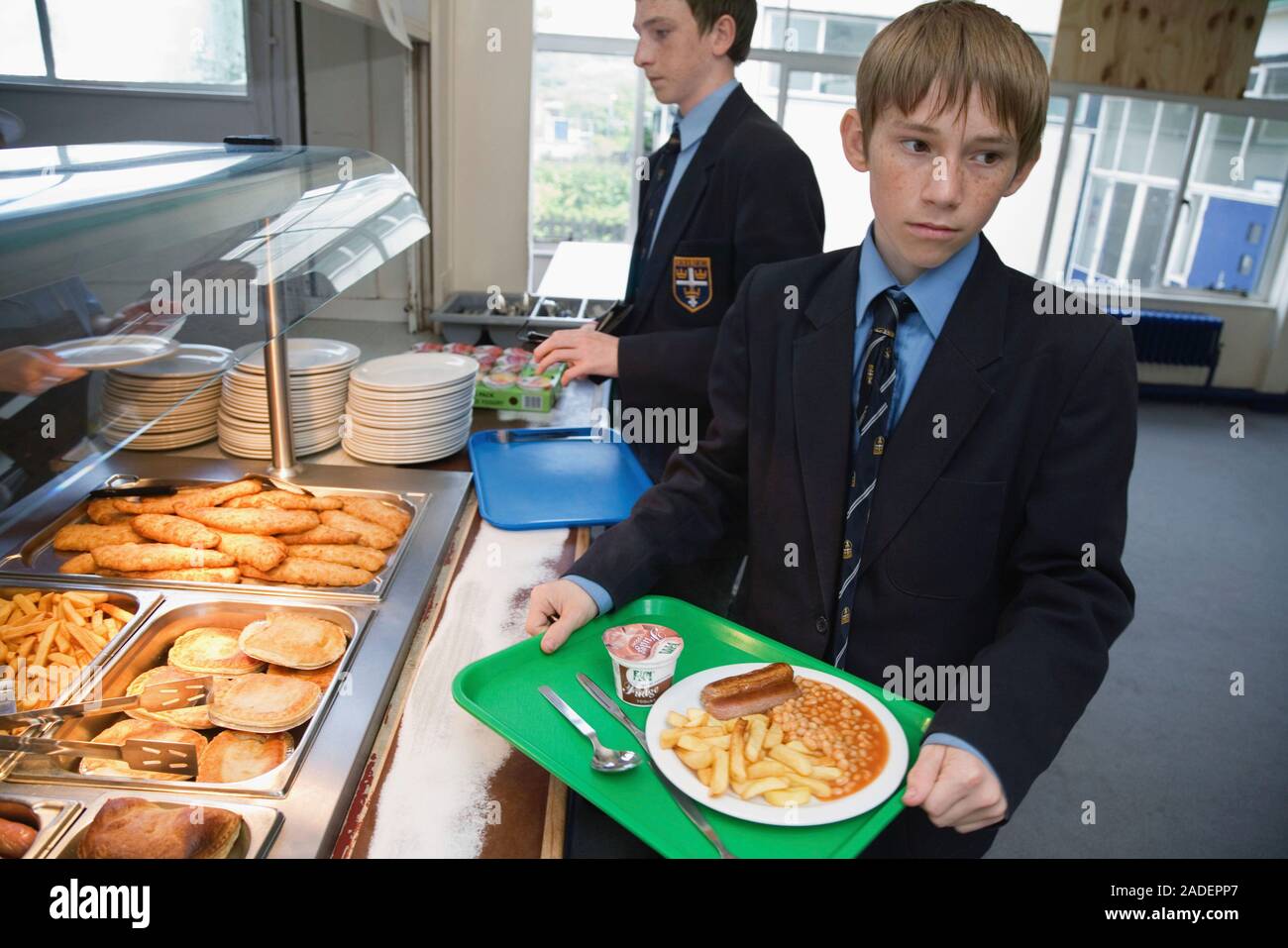 Secondary school students queuing up for lunch at school canteen Stock ...