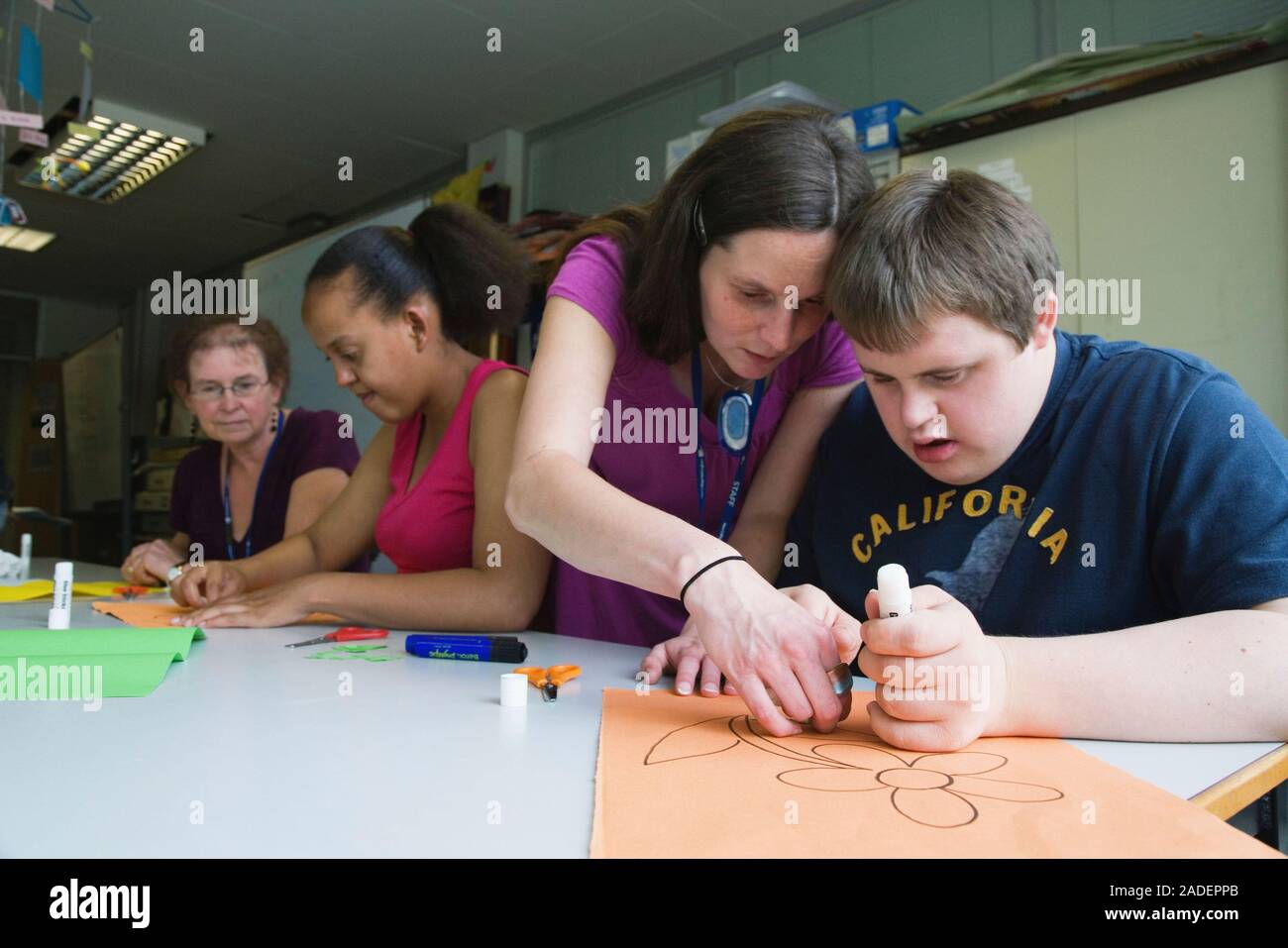 Teachers helping students with learning disabilities in art class Stock ...