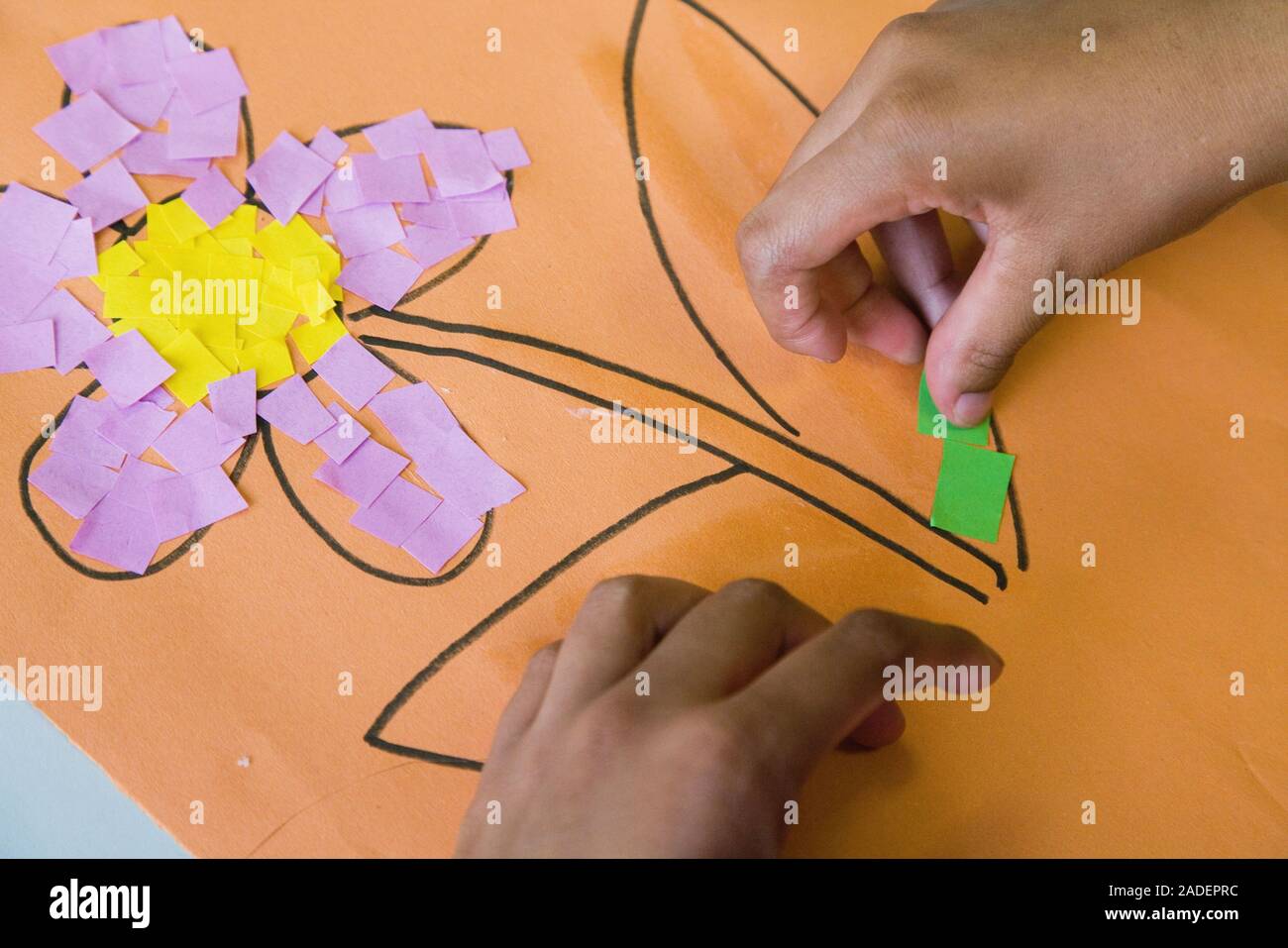 Teenager with learning disability making a picture of a flower in an ...