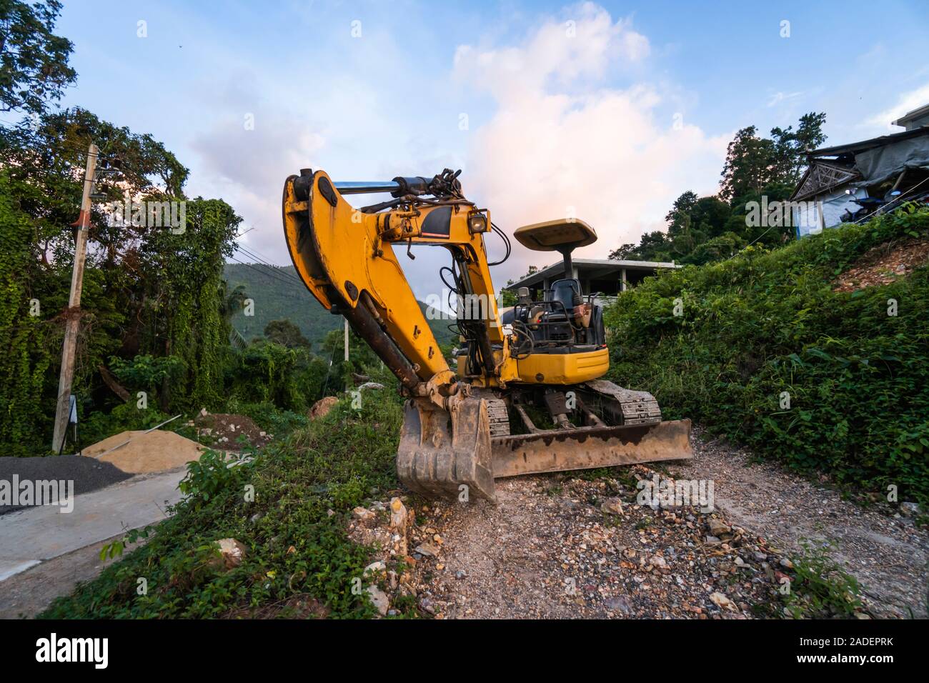 The modern excavator on the construction site with sunset sky. Large ...