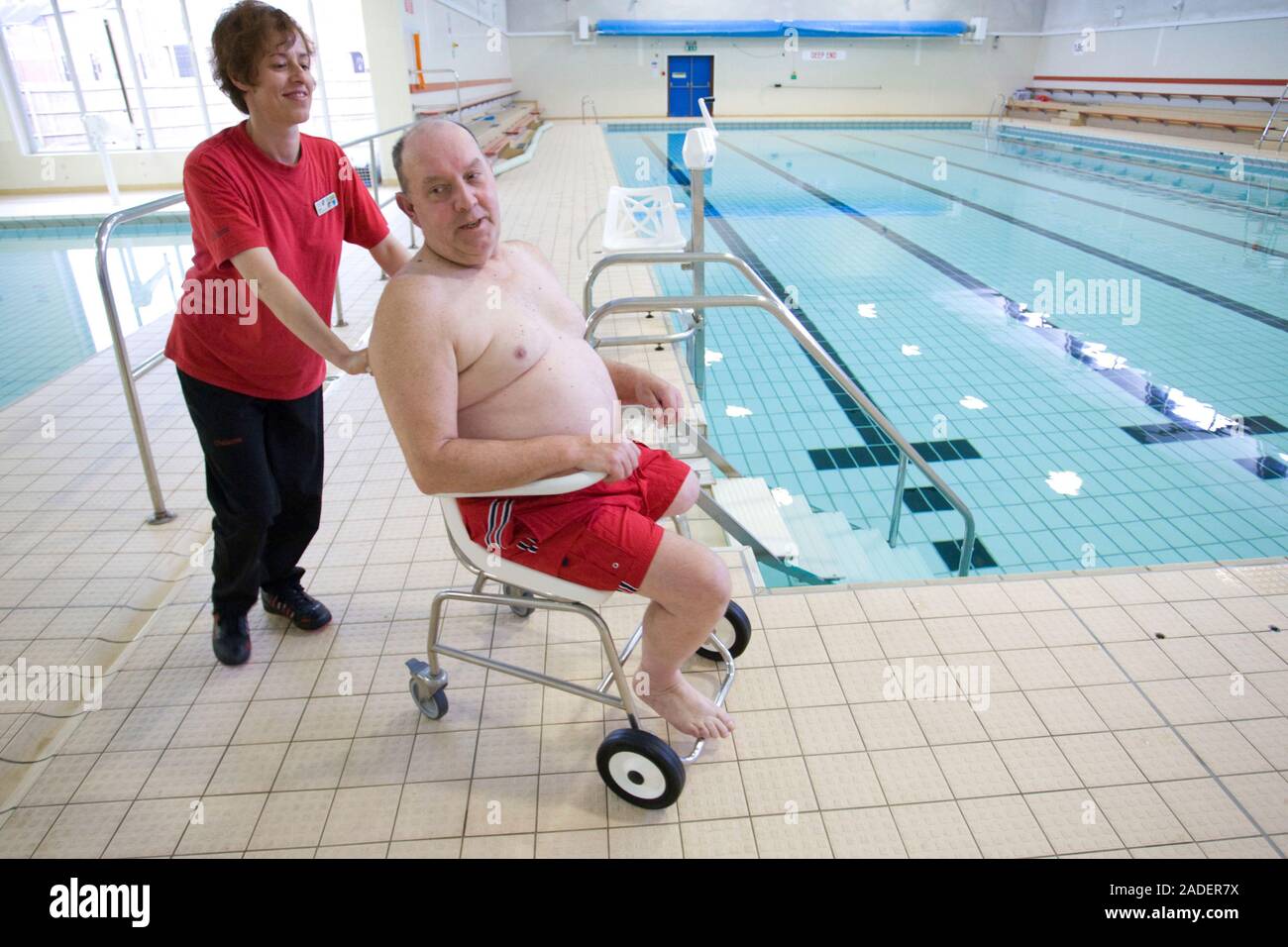 Disabled man leaving the swimming pool at his local leisure centre with ...
