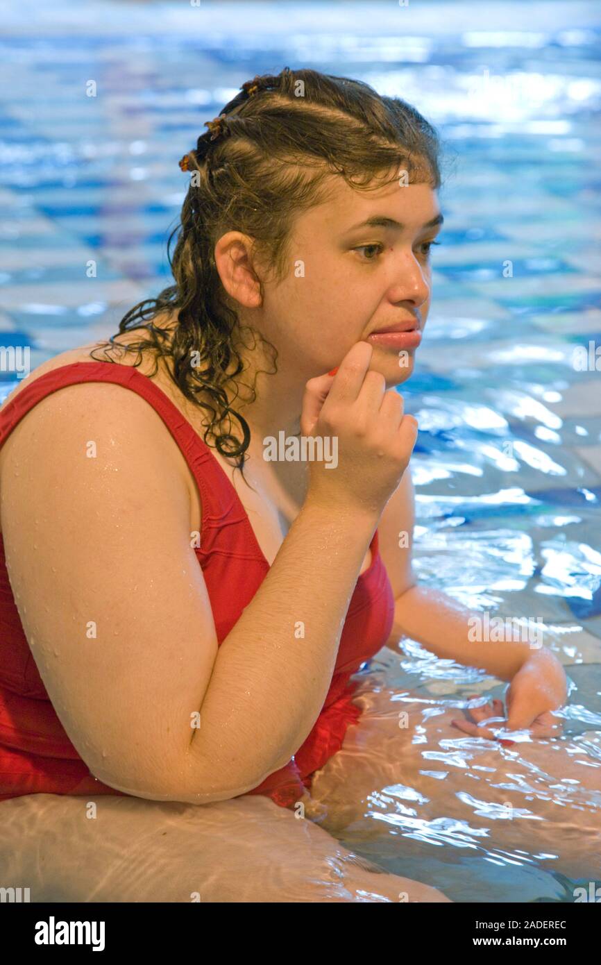 Day service user with learning disability playing in the water at a ...