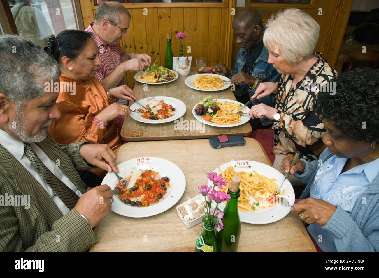 Group of friends out together eating in a restaurant Stock Photo - Alamy
