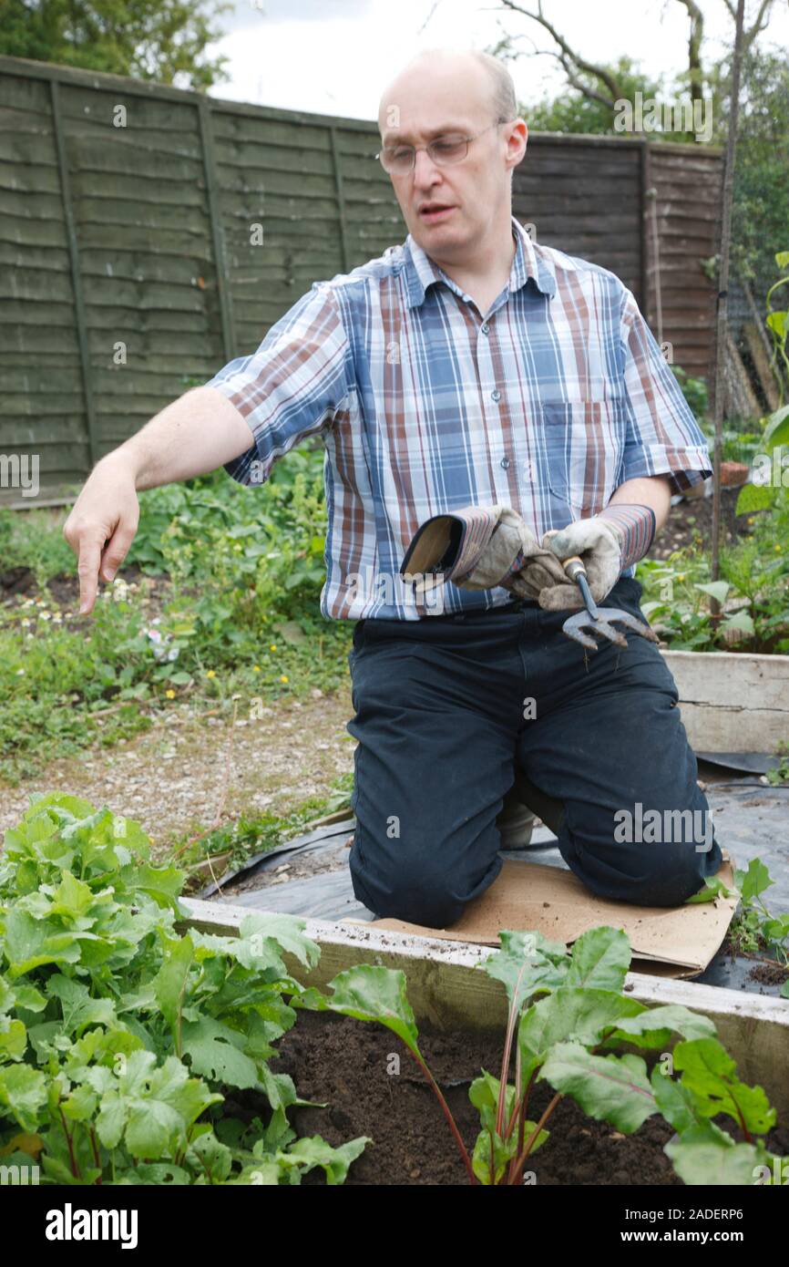 Man with learning disability working on allotment Stock Photo - Alamy