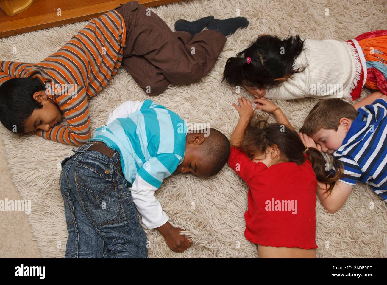 Multiracial group of children playing dead Stock Photo - Alamy