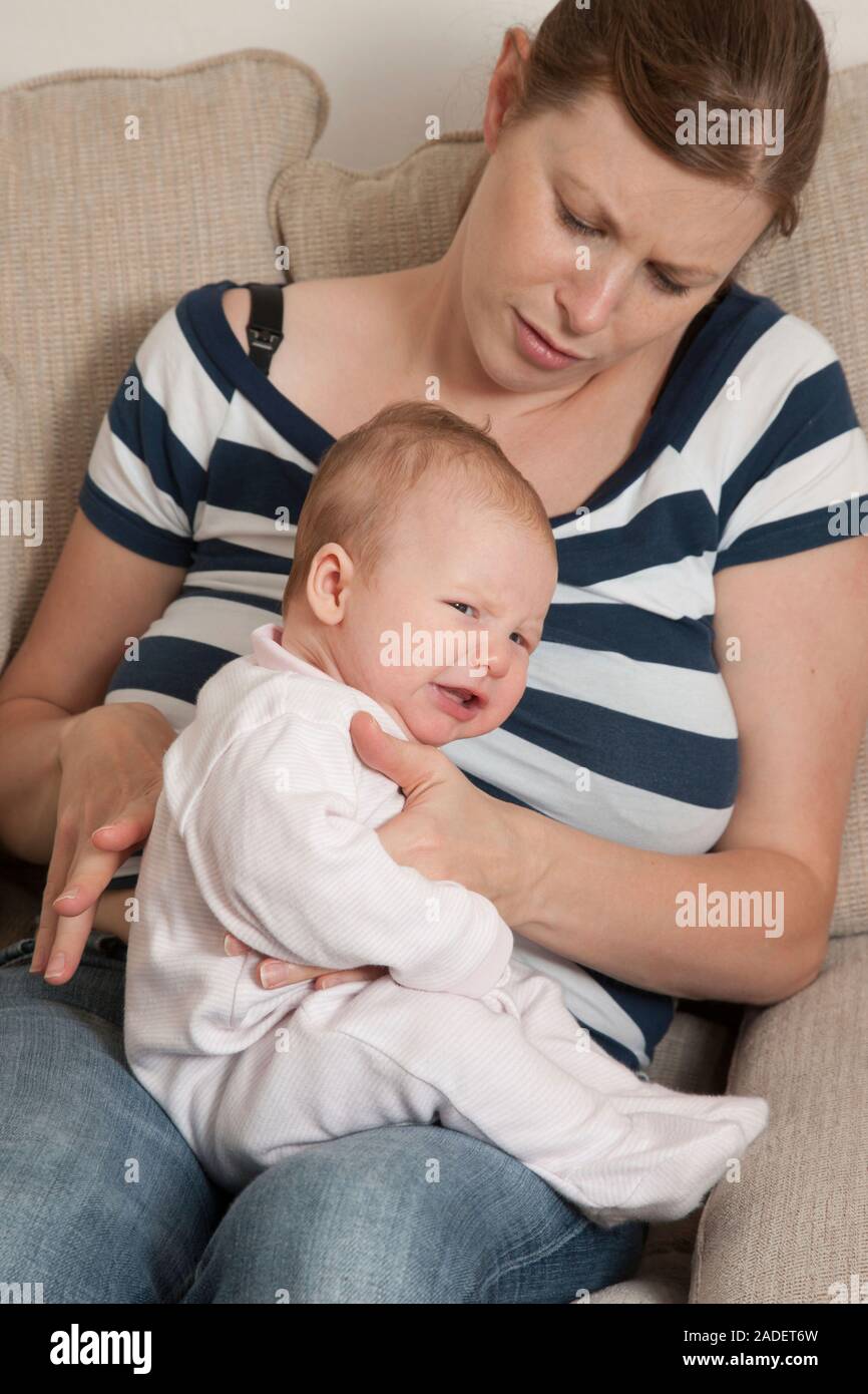 Mother winding baby after feeding. (This photo has clearance for the ...
