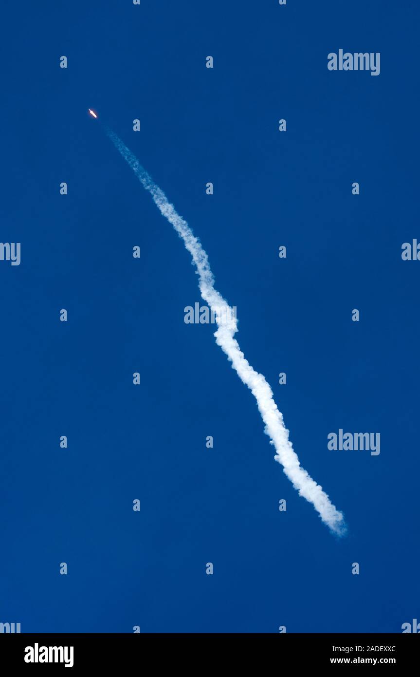 A condensation trail marks the path of a SpaceX Falcon 9 rocket, which ...