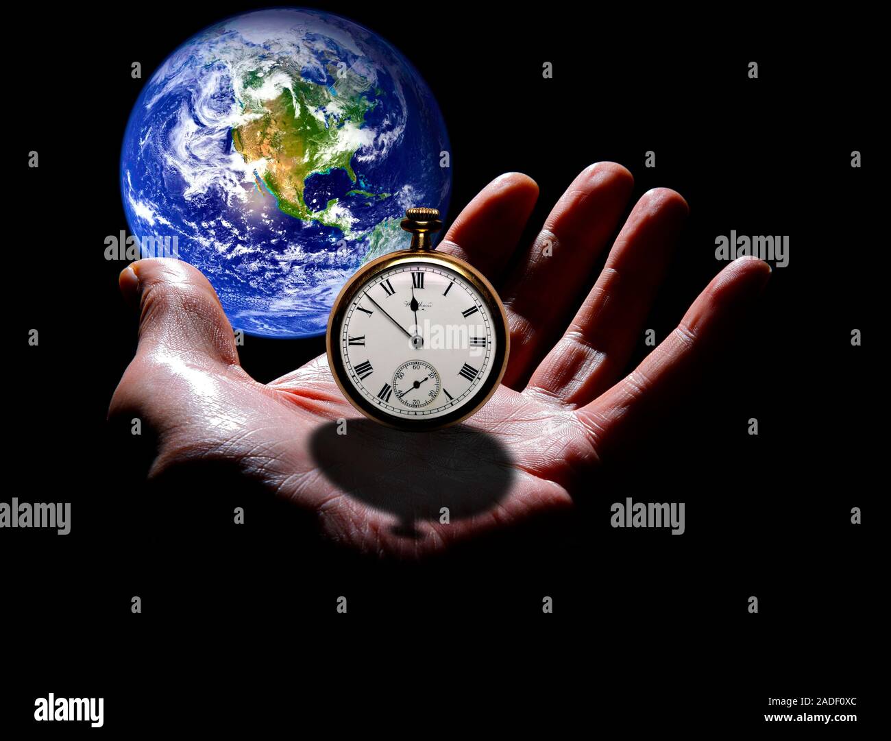 Earth with hand and stopwatch. Composite image illustrating the idea ...