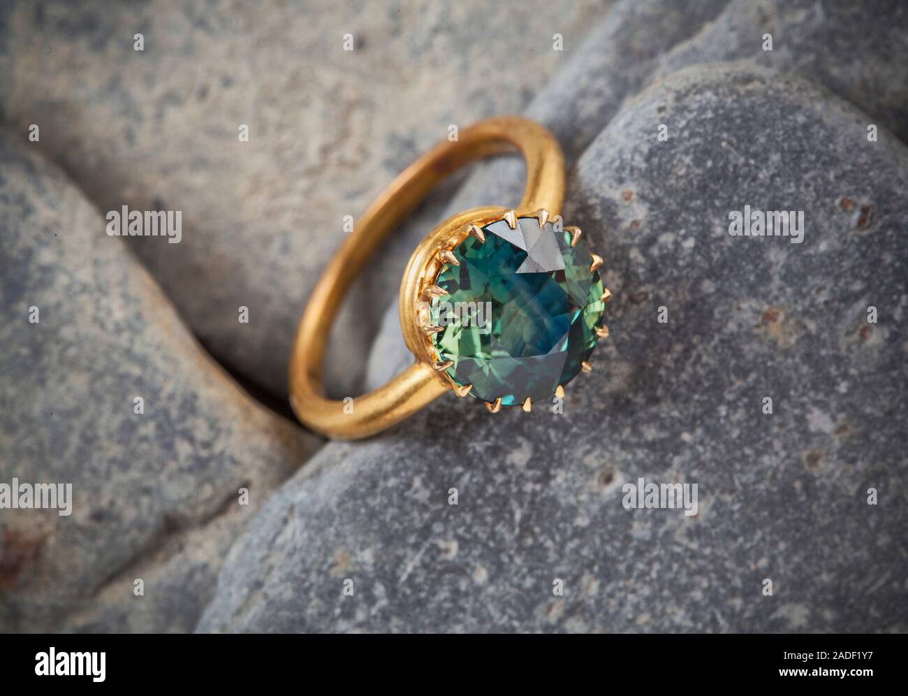 A green sapphire, one of the gem varieties of corundum, set in a gold ...