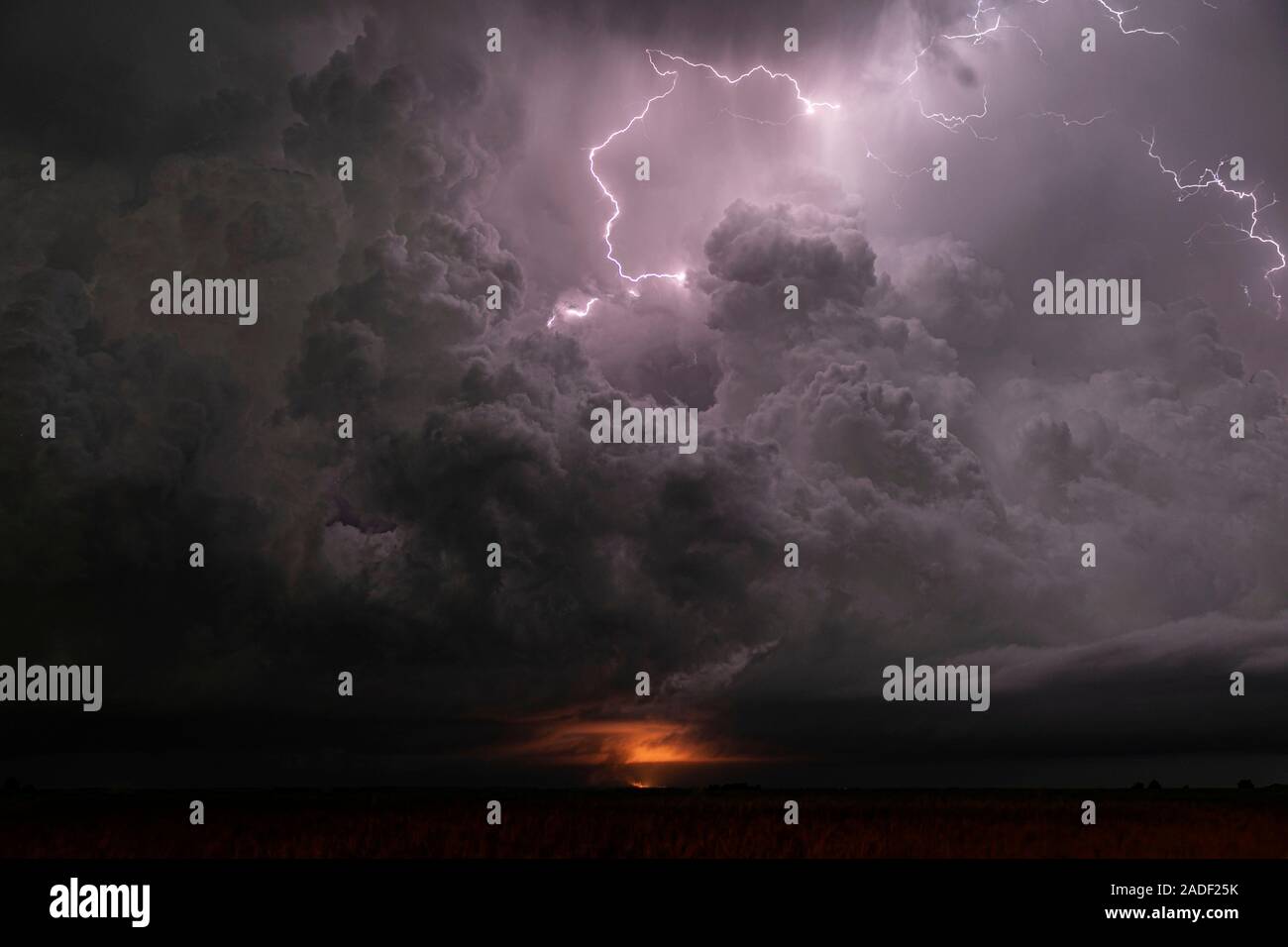 Lightning strike over wildfire. Time-exposure image of a lightning ...