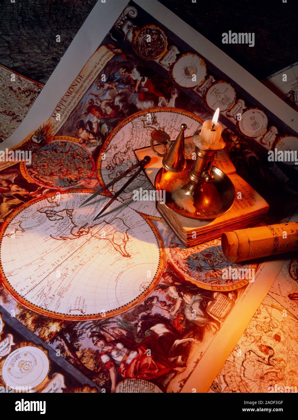 World map. Lighted candle on top of a book which is on top of an ...