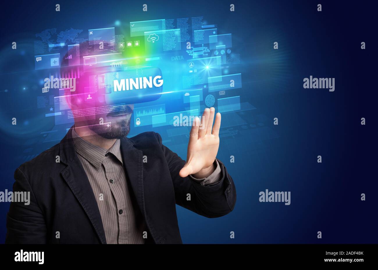 Businessman looking through Virtual Reality glasses with MINING ...