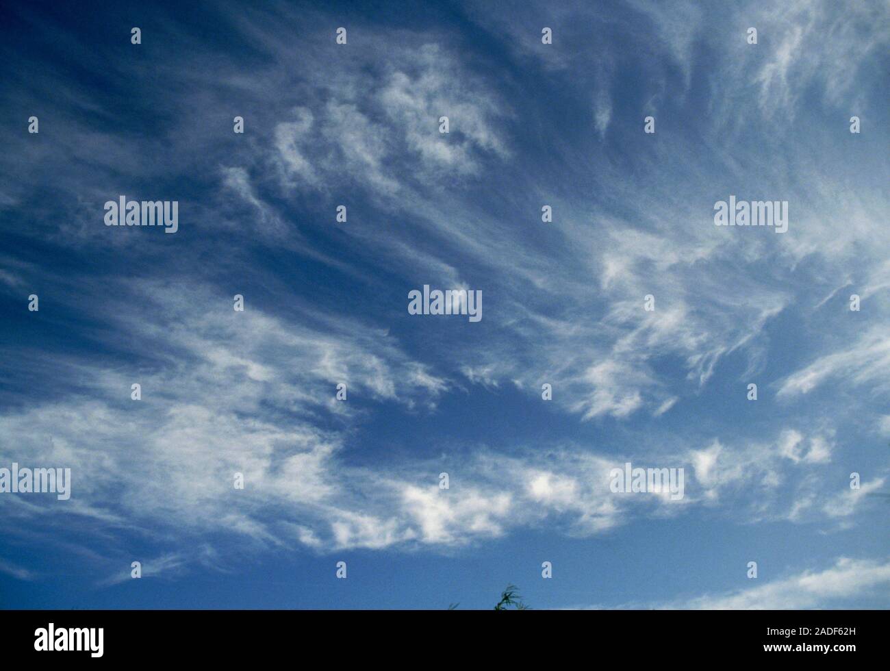 Cirrus cloud. Wisps of cirrus cloud in the sky. Cirrus is a high ...