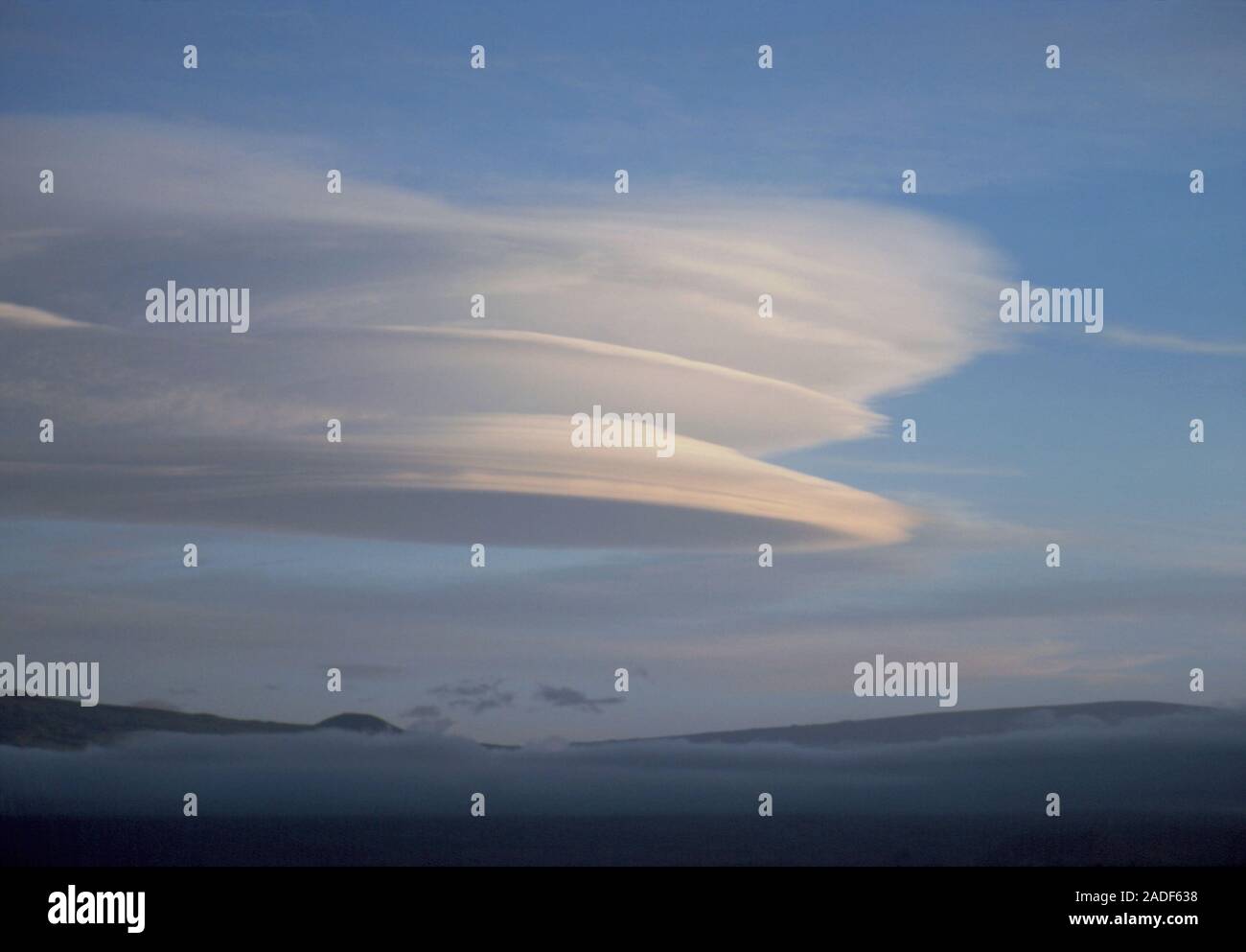 Lenticular clouds. Stack of lenticular clouds, named for their smooth ...