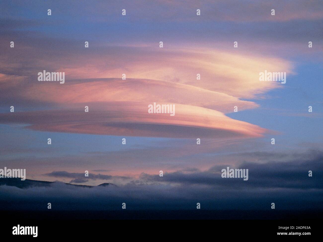 Lenticular clouds. Stack of lenticular clouds, named for their smooth ...