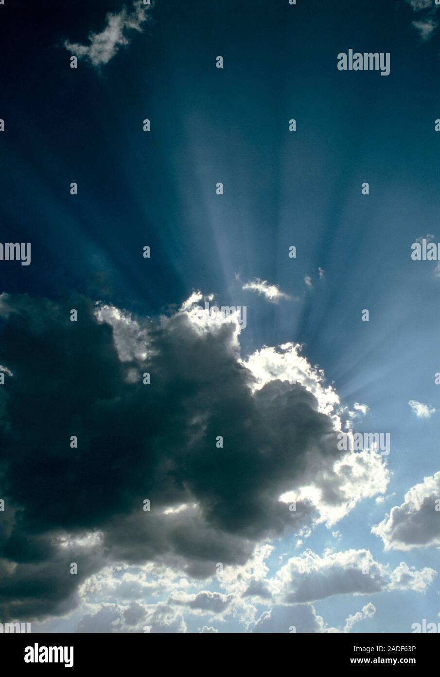Sun rays. View of a large cumuliform cloud showing rays of sunlight ...