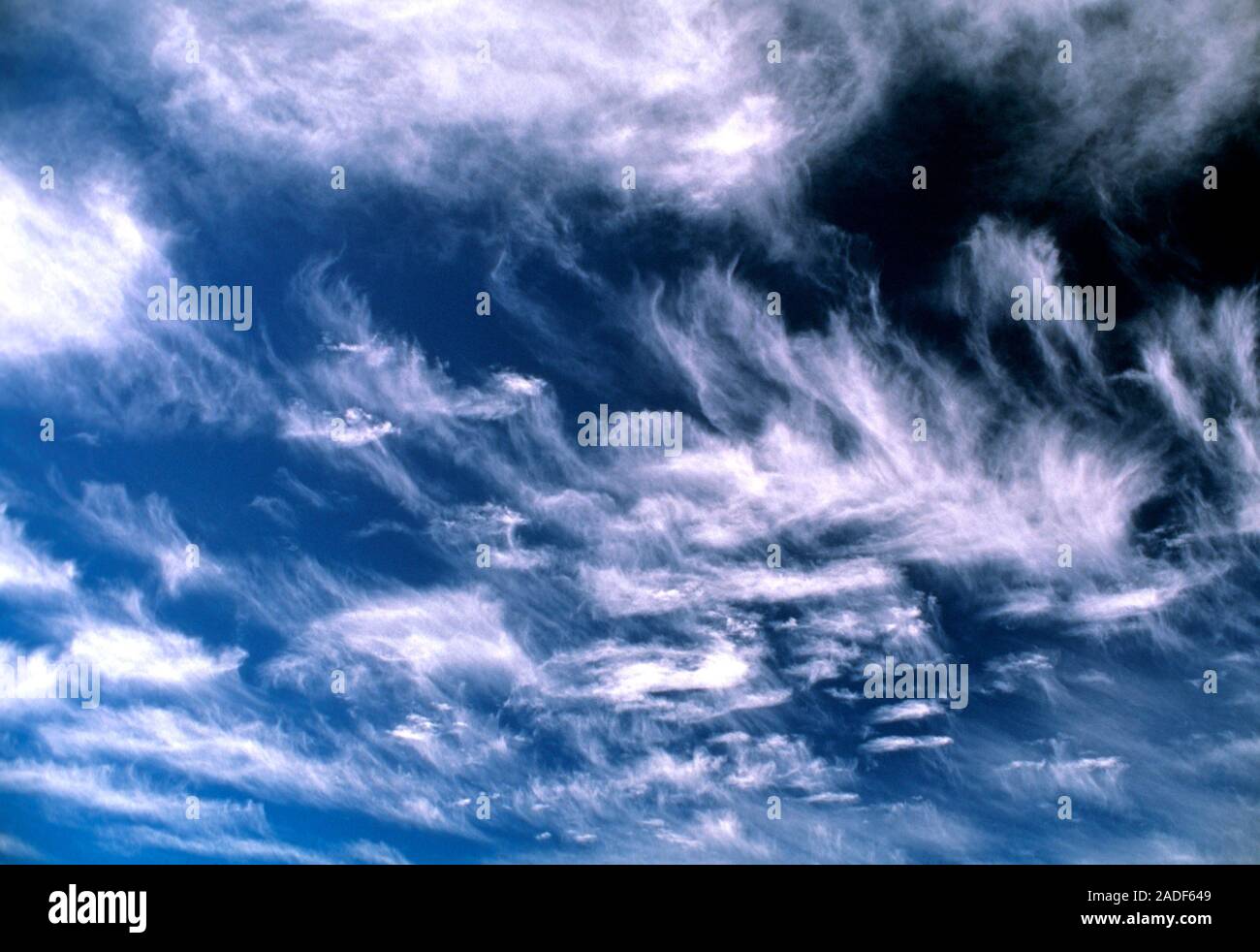 Cirrus clouds. Wispy strands of cirrus cloud. Cirrus clouds are found ...