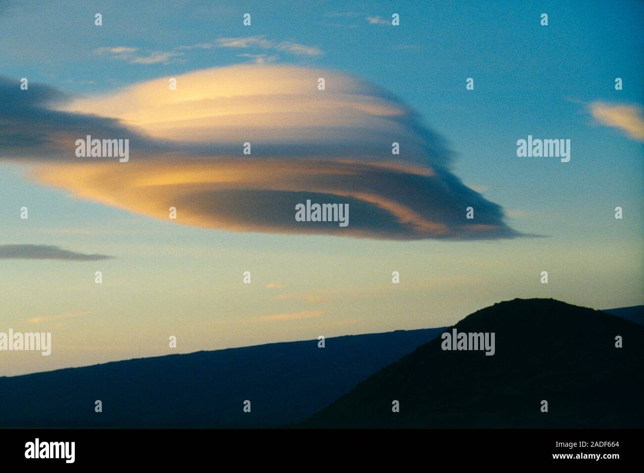 Lenticular cloud. This cloud is seen over mountains and mountain ranges ...