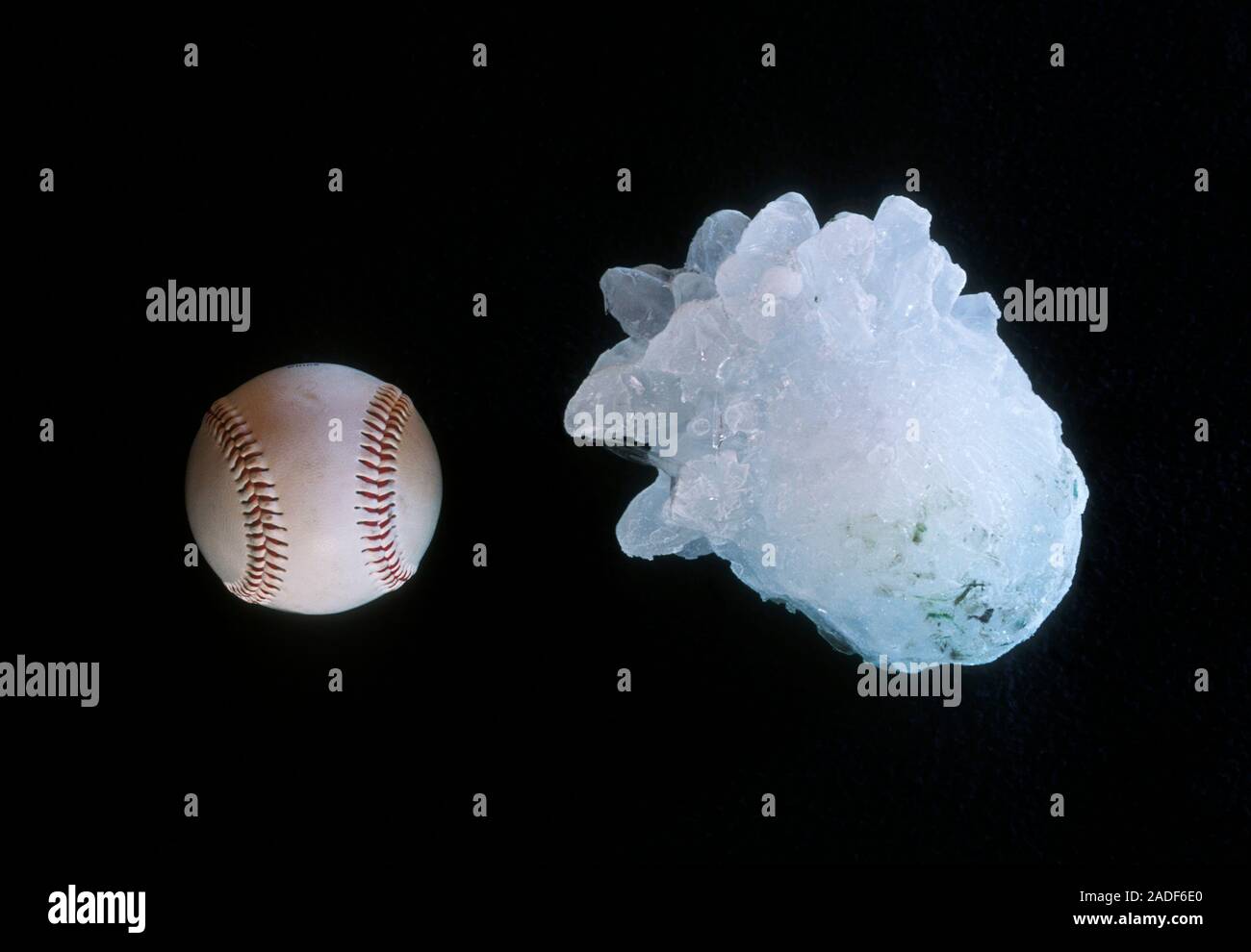 Giant hailstone next to a baseball. Hailstones are lumps of ice formed ...
