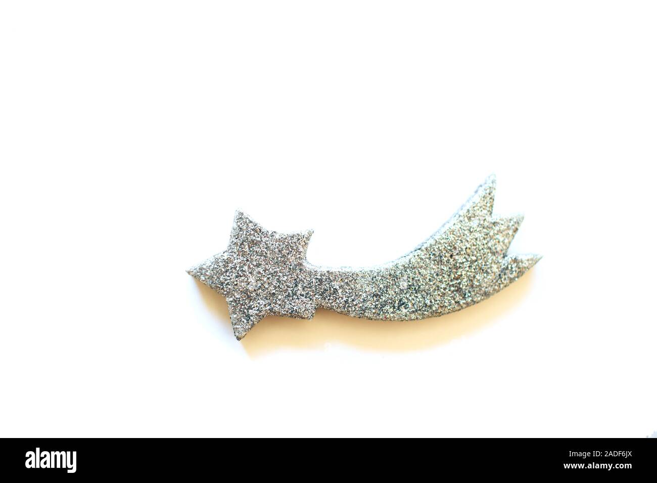 Minimal composition with sparkling handmade silver shooting star toy ...