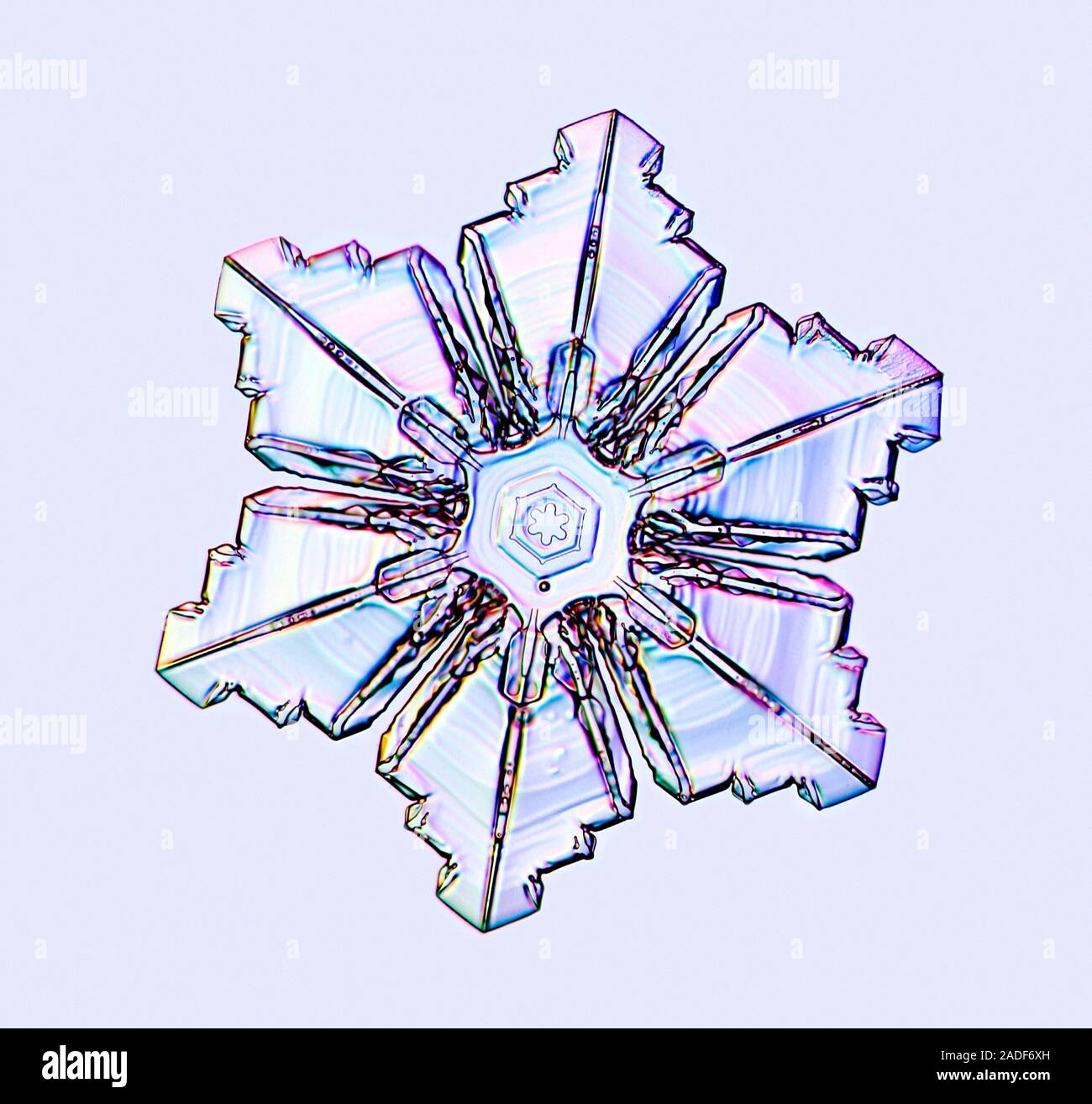 Snowflake, light micrograph. This form of snow crystal is known as a ...