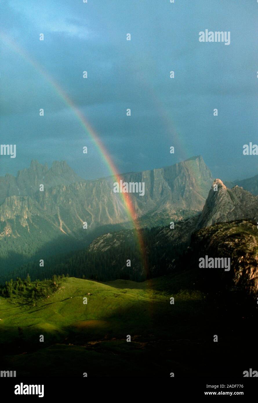 Rainbow. Double arc rainbow seen over mountains. The outer arc is much ...